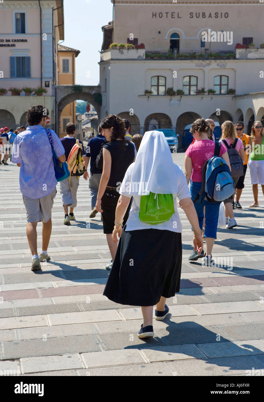 Nun, tourists and pilgrims Assisi Umbria italy Stock Photo - Alamy