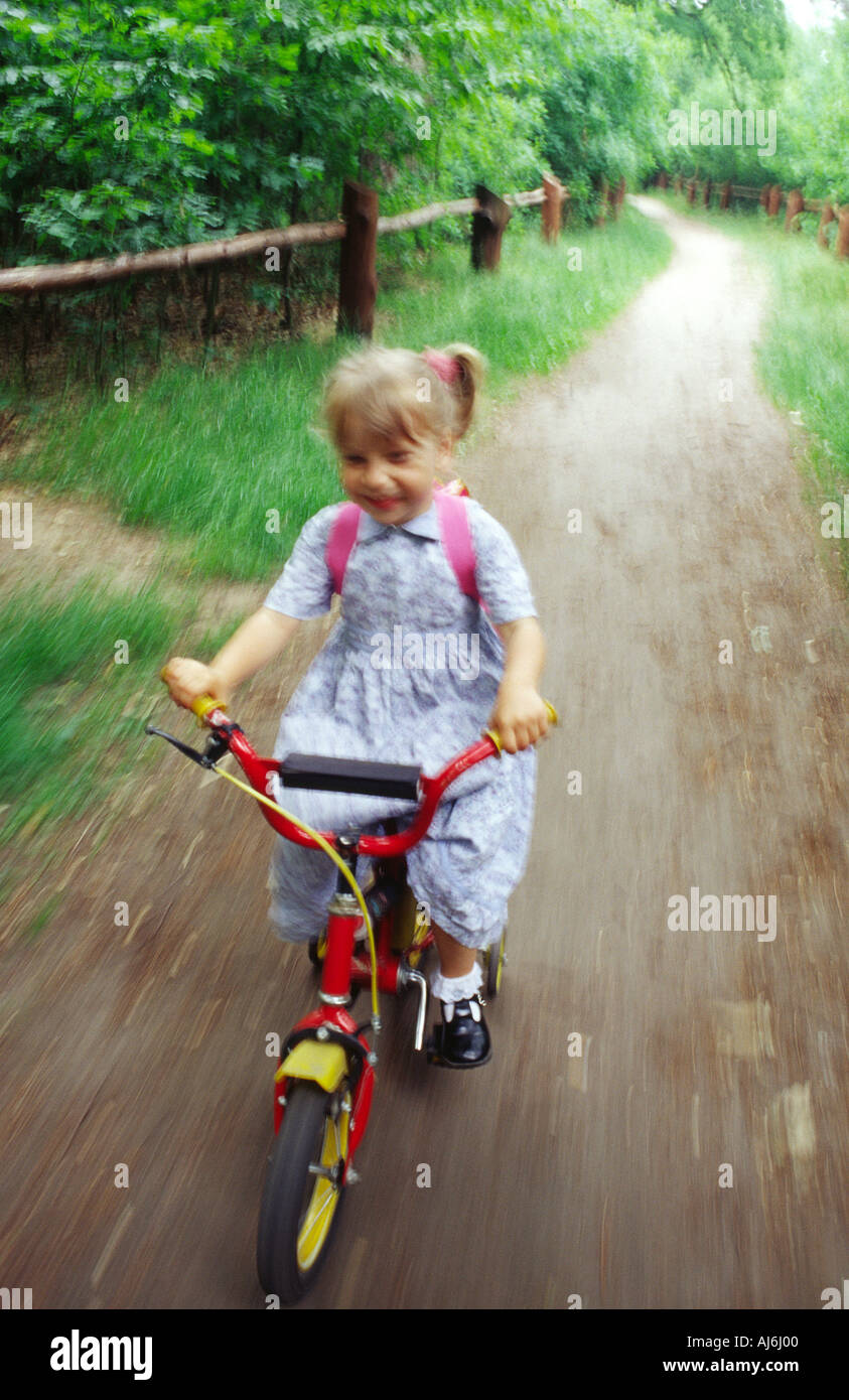 Small girl riding a bike outdoor Stock Photo - Alamy