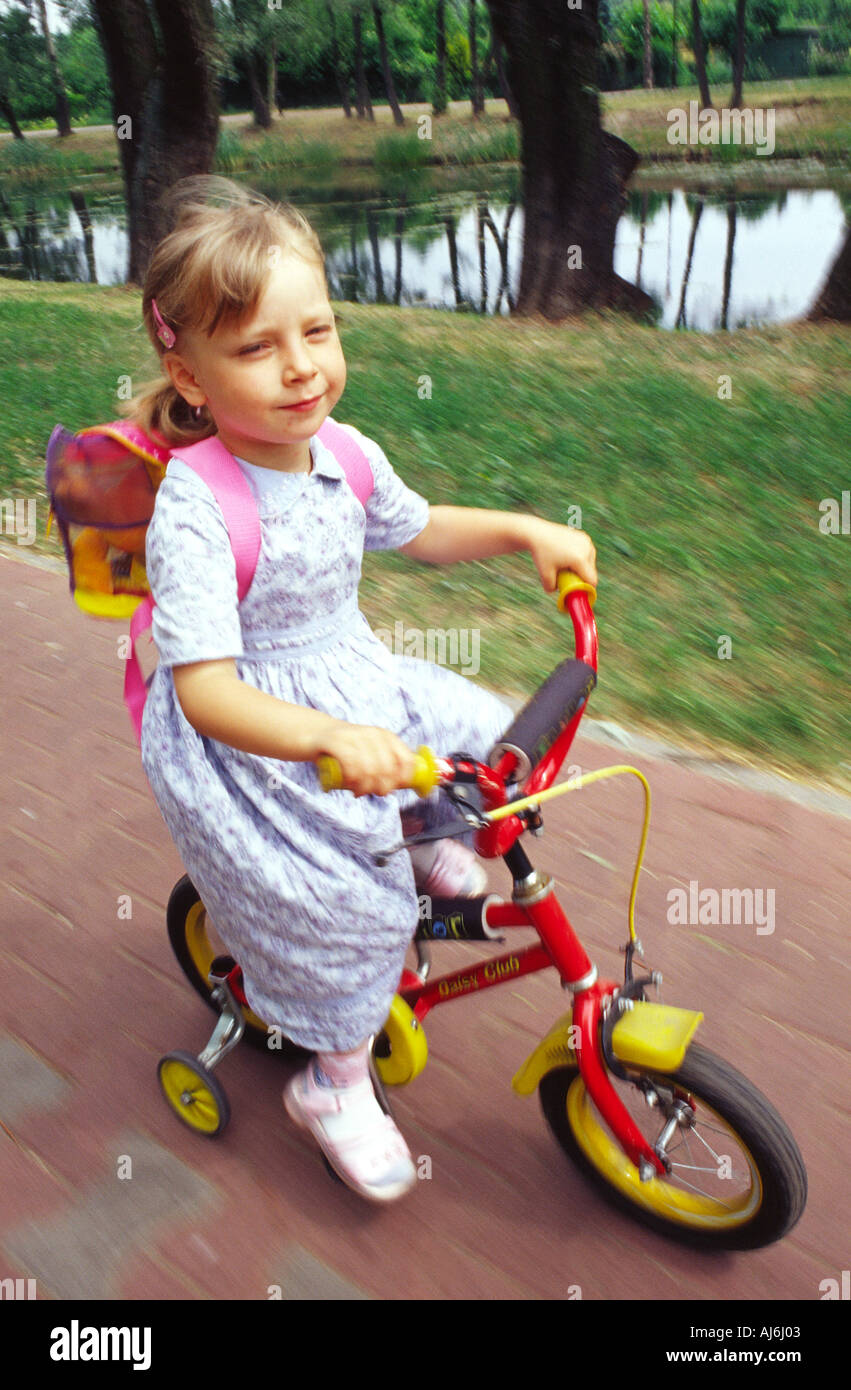 Small girl riding a bike outdoor Stock Photo - Alamy