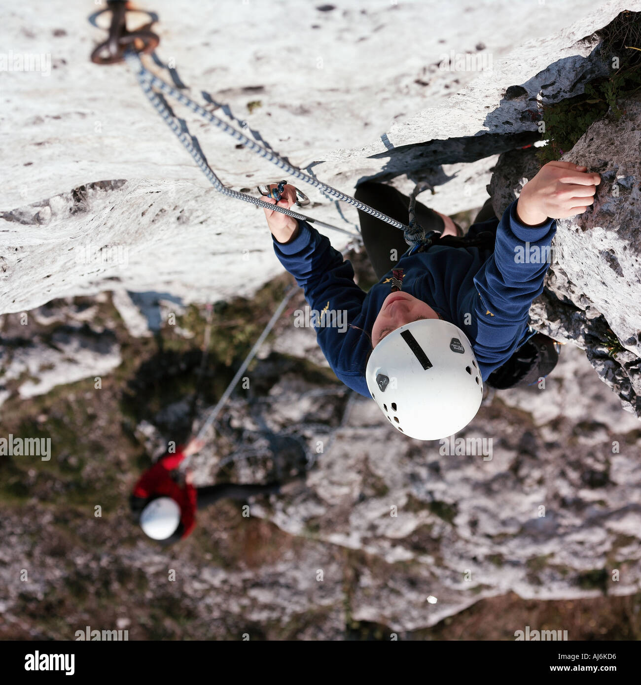 Two people climbing mountain Stock Photo - Alamy