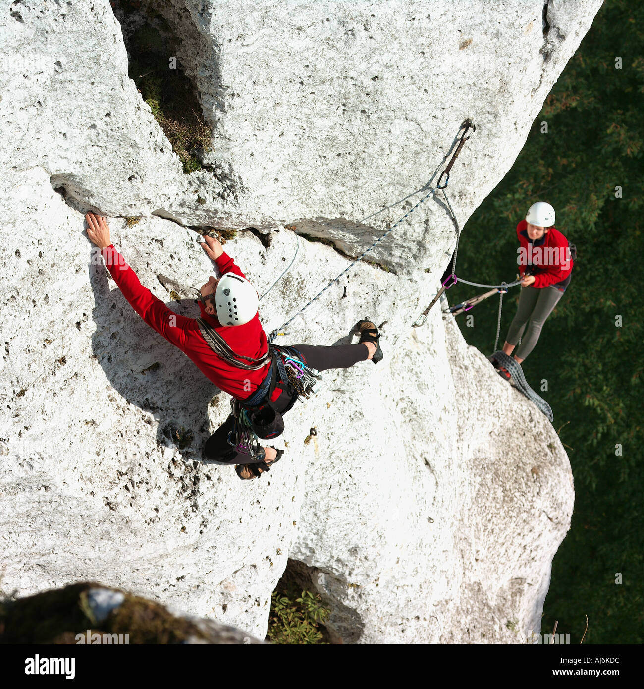 Two people climbing mountain Stock Photo - Alamy