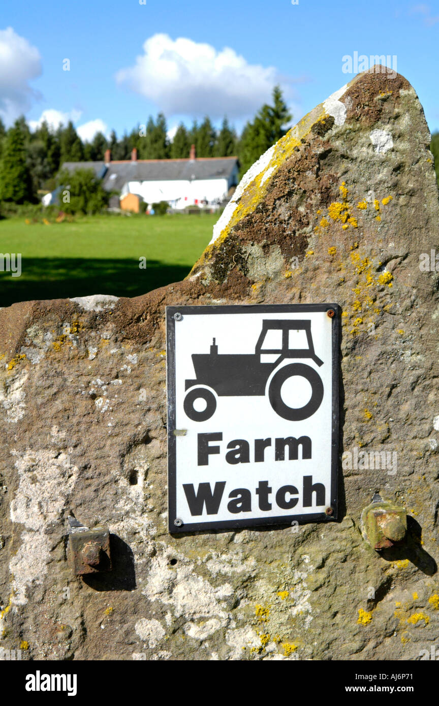 FARM WATCH sign with tractor logo on old stone gate post at the ...