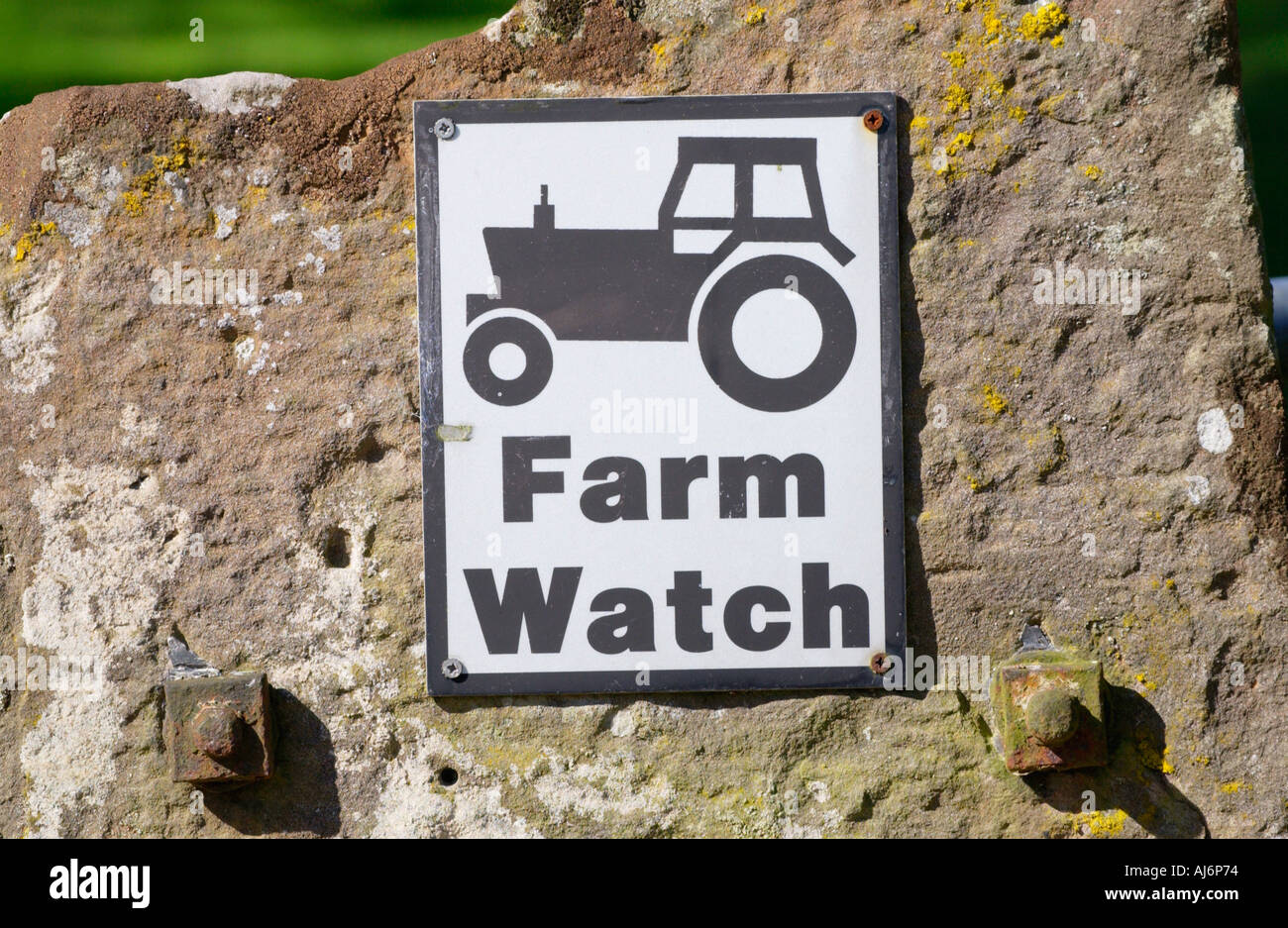 FARM WATCH sign with tractor logo on old stone gate post at the ...