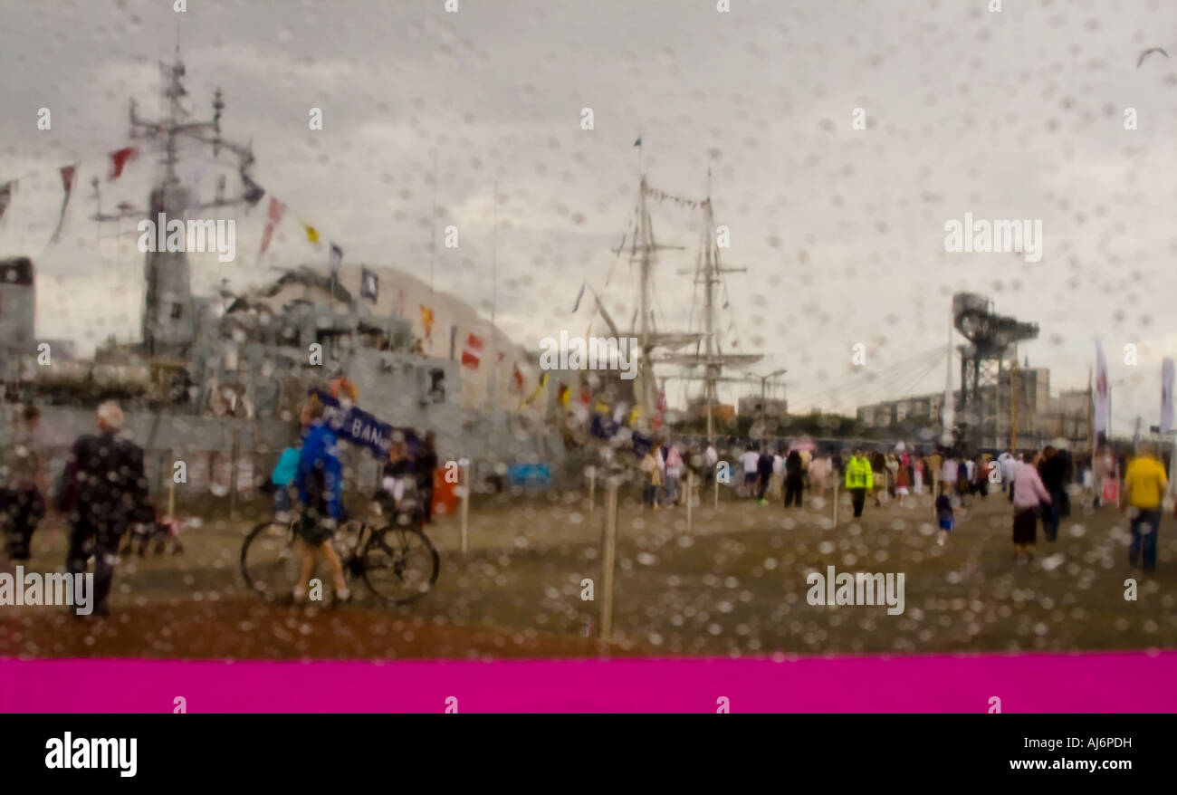 Blurred people seen through raindrops on a transparent umbrella at ...