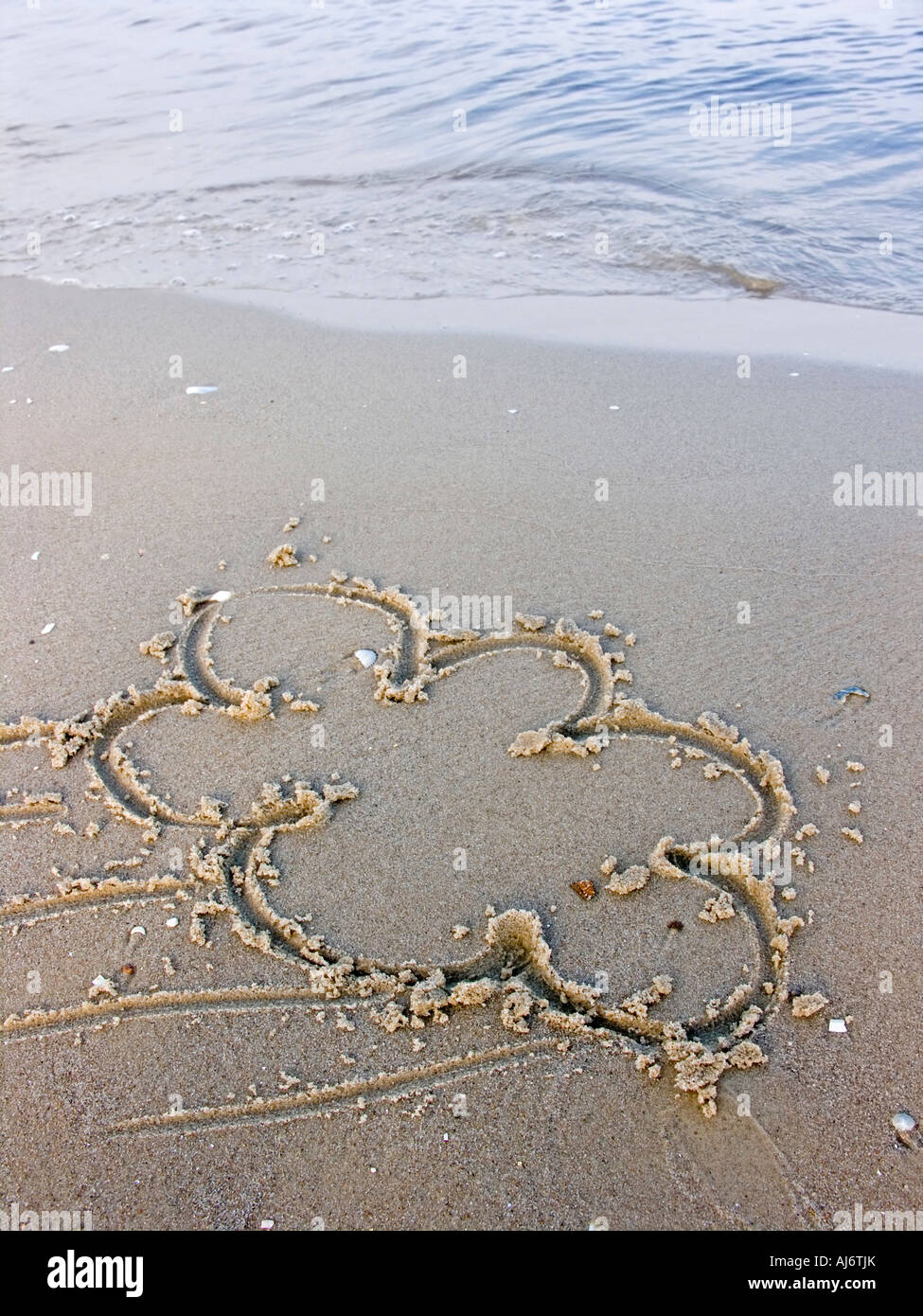 drawing of a cloud and rain on sand on beach Stock Photo - Alamy