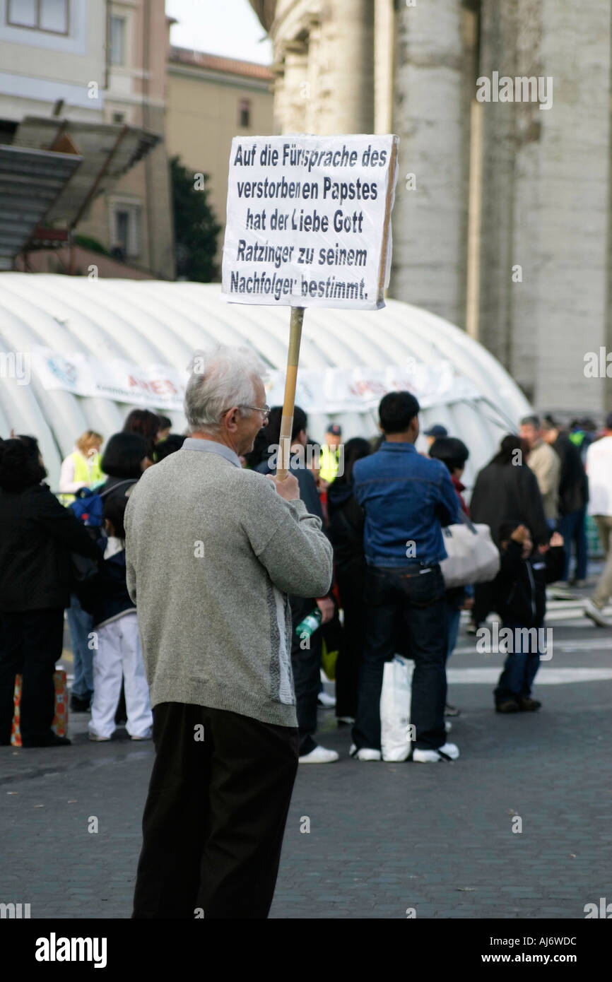 Elderly man holding sign Vatican Italy Stock Photo - Alamy