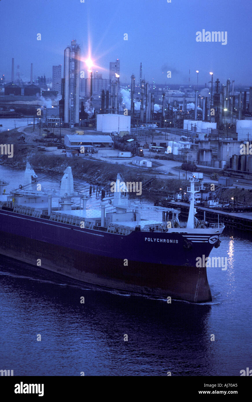 Cargo ship in Ship Channel with refineries in background in Houston ...