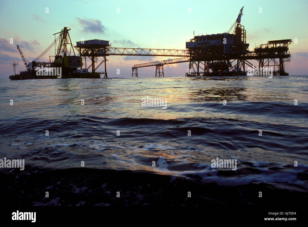 Offshore platforms with work barge Stock Photo - Alamy