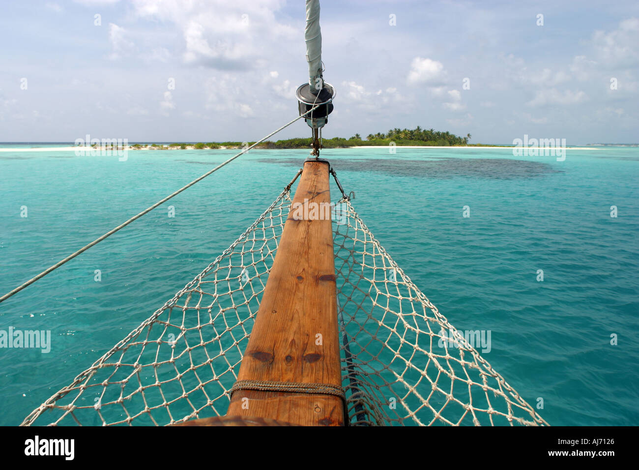 sailing ship approaching idyllic tropical island, Maldives Stock Photo ...