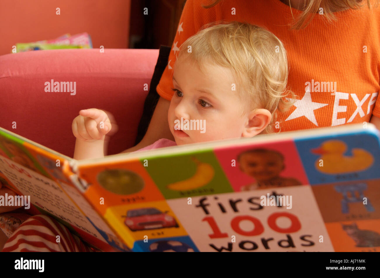 Young child learning to read Stock Photo - Alamy