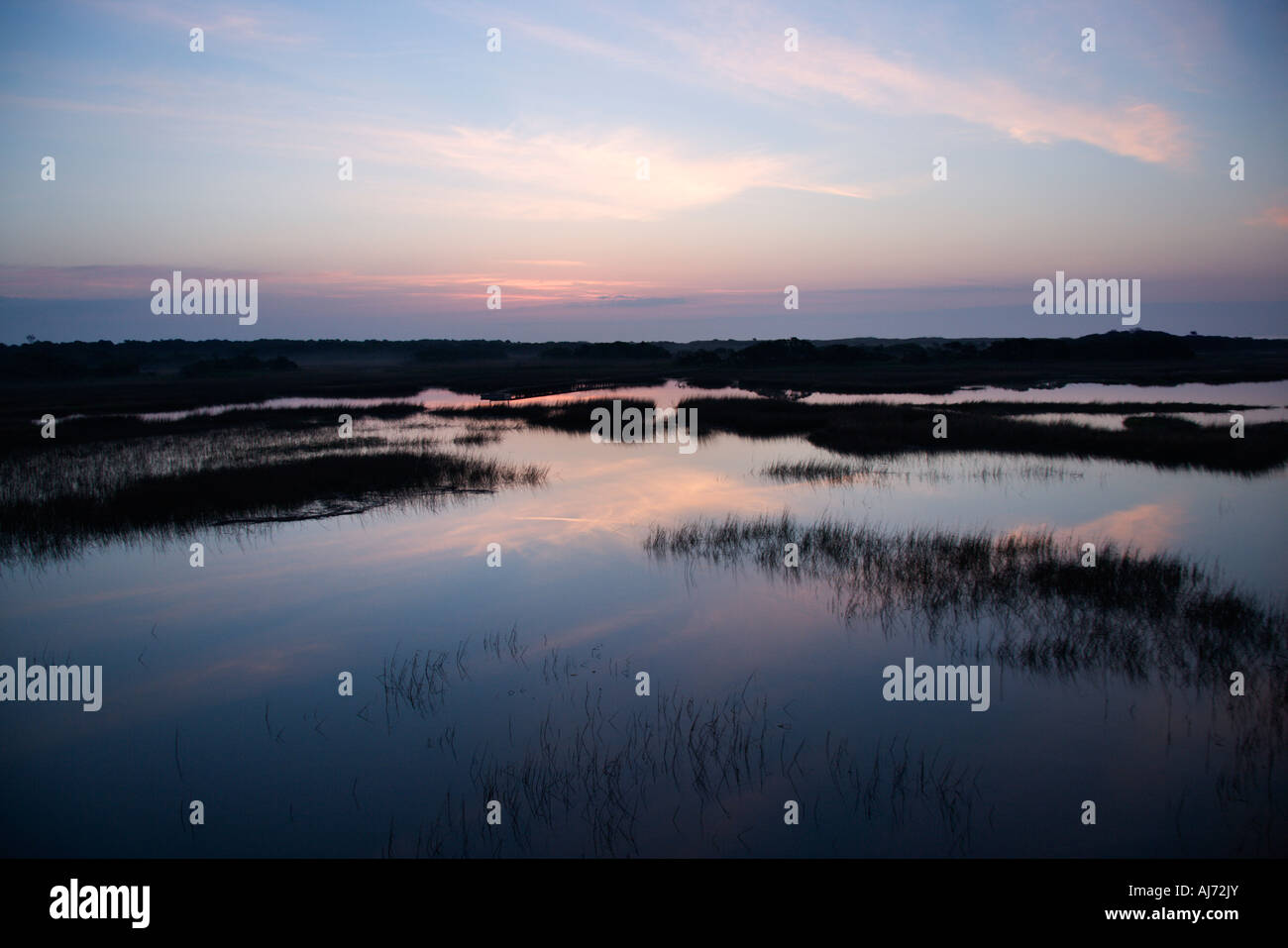 Sky reflecting in water in marsh area on Bald Head Island North ...