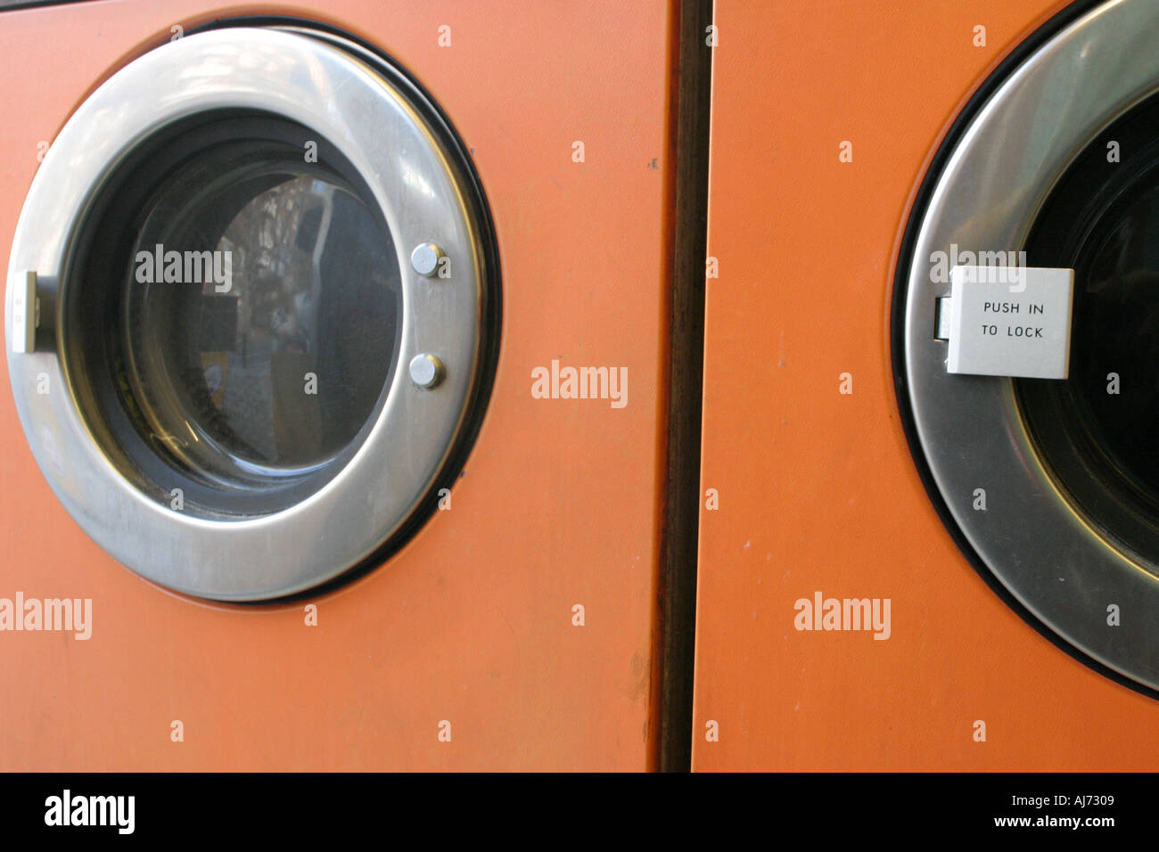 Doors of industrial Washing machines in orange Stock Photo - Alamy