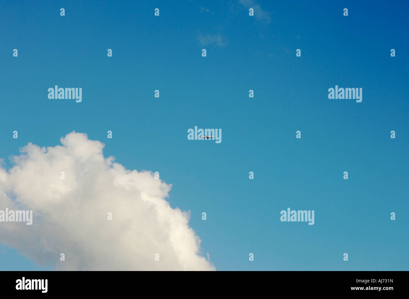 distant plane in deep blue sky Stock Photo - Alamy