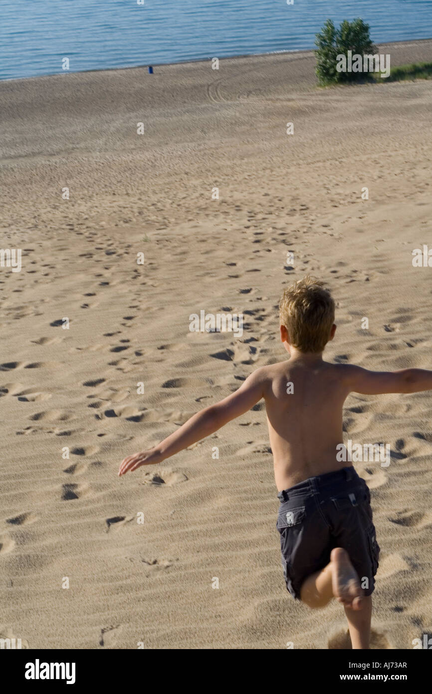 Boy running down the beach hi-res stock photography and images - Alamy