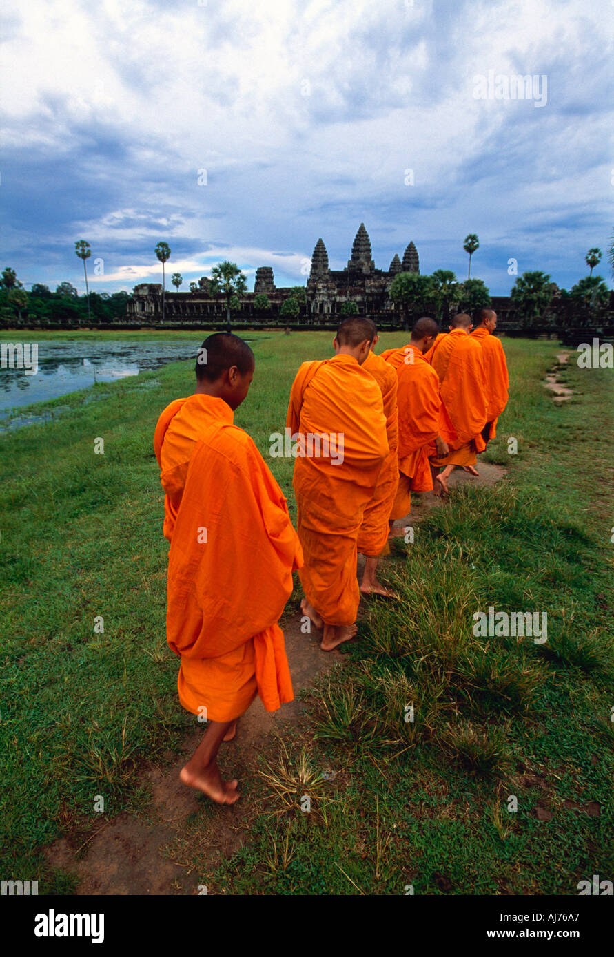 Cambodia, Angkor Wat, Monks walking towards Angkor Wat Temple Stock ...