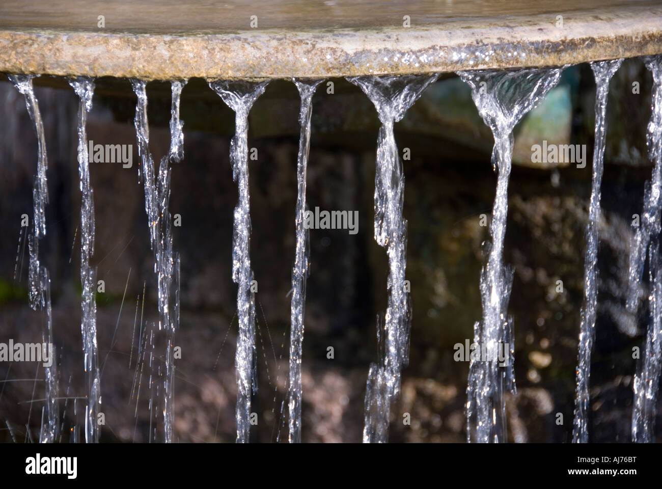 Stock Photo of water splashing over the edge of a stone lip Stock Photo ...