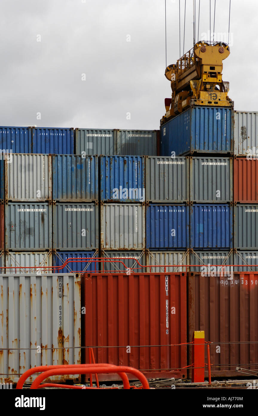 Shipping containers being loaded on to the deck of a container ship ...