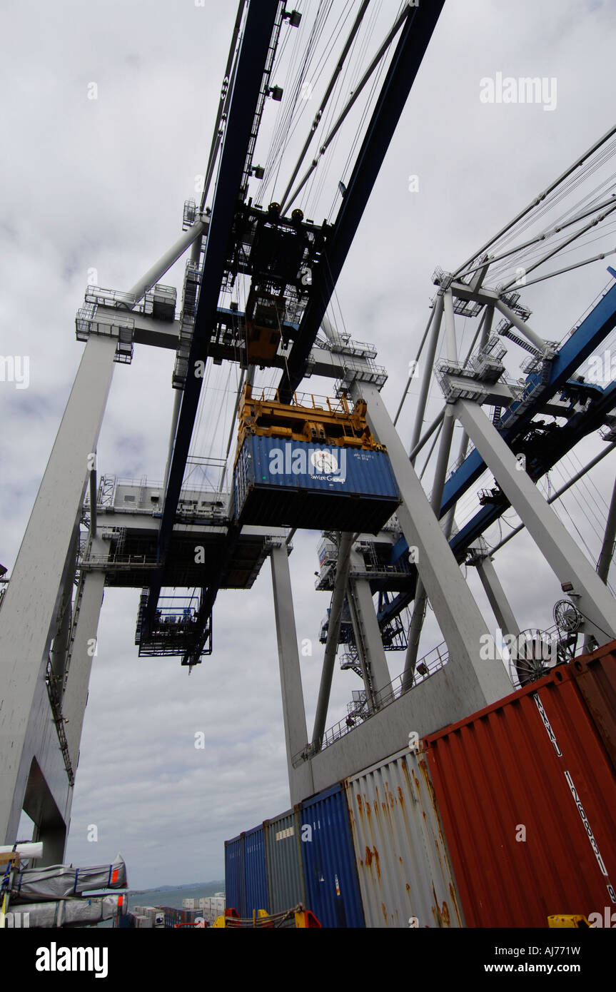 Shipping containers being loaded on to the deck of a container ship by ...