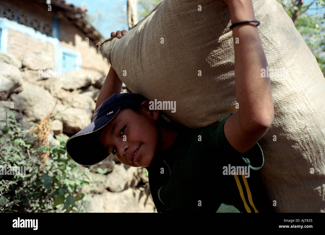 Children working child labour carrying hi-res stock photography and ...