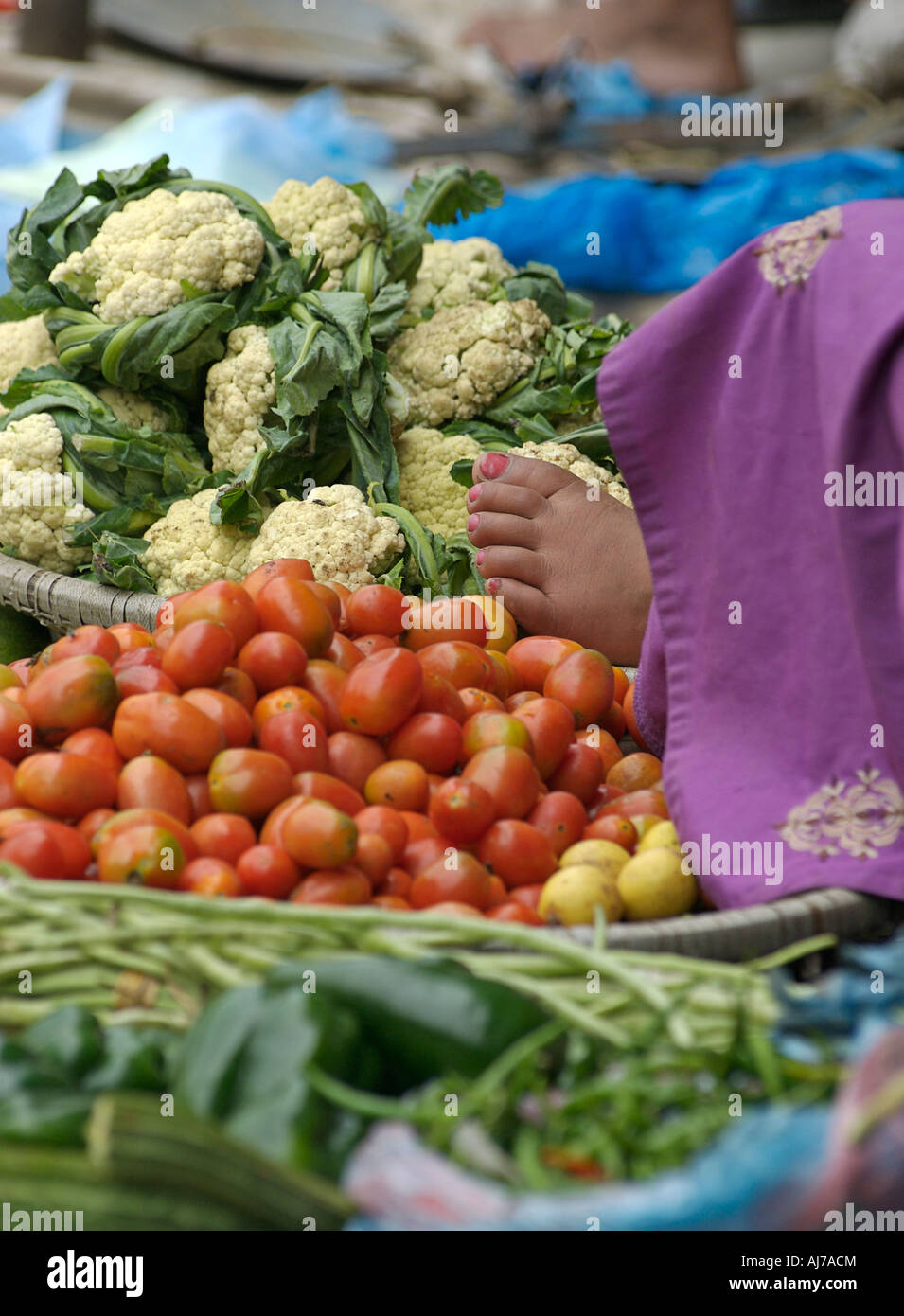 Relaxed vegetable vendor s feet amidst her produce Kathmandu Nepal ...
