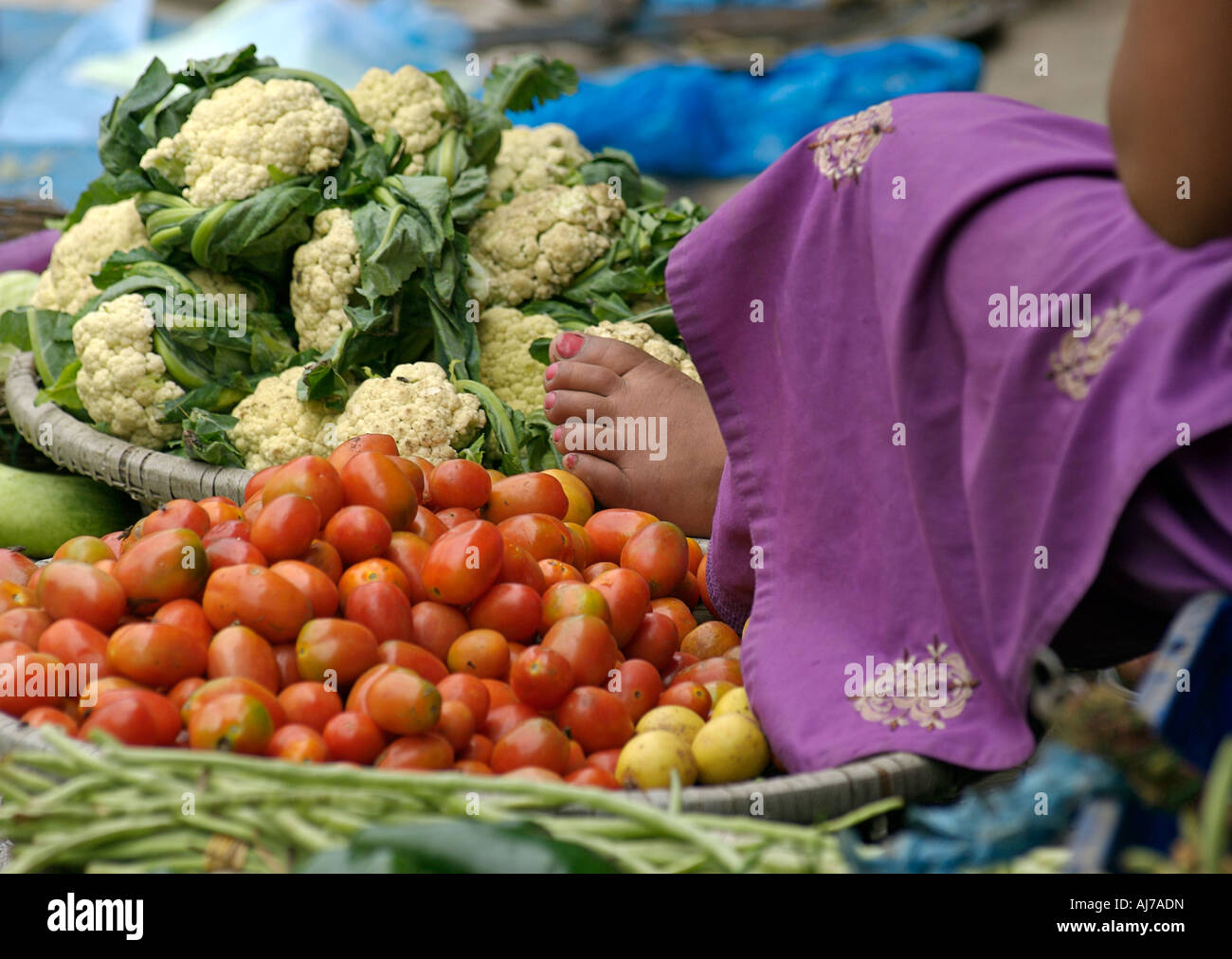 Relaxed vegetable vendor s feet amidst her produce Kathmandu Nepal ...