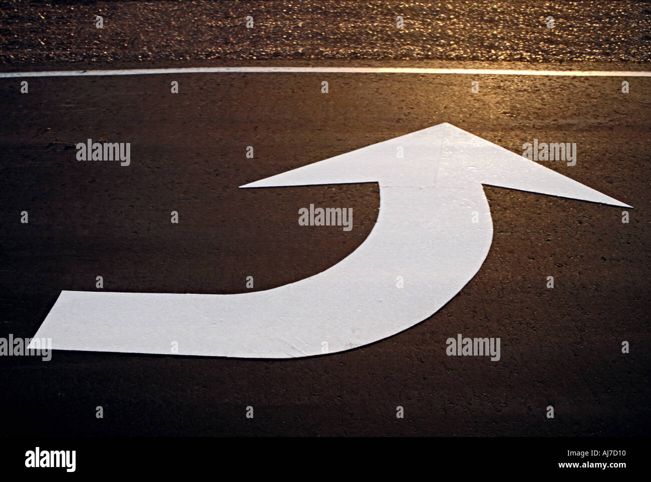 sun shining on left turn only road sign Stock Photo - Alamy