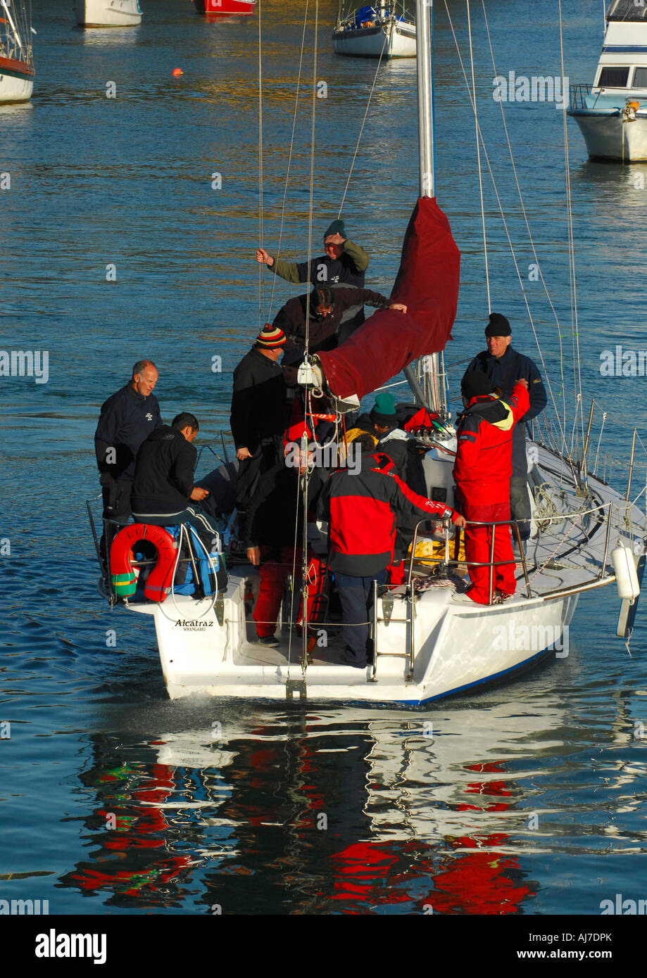 Sailing boat and crew in red weather gear, Opua harbour, Russell, Bay ...