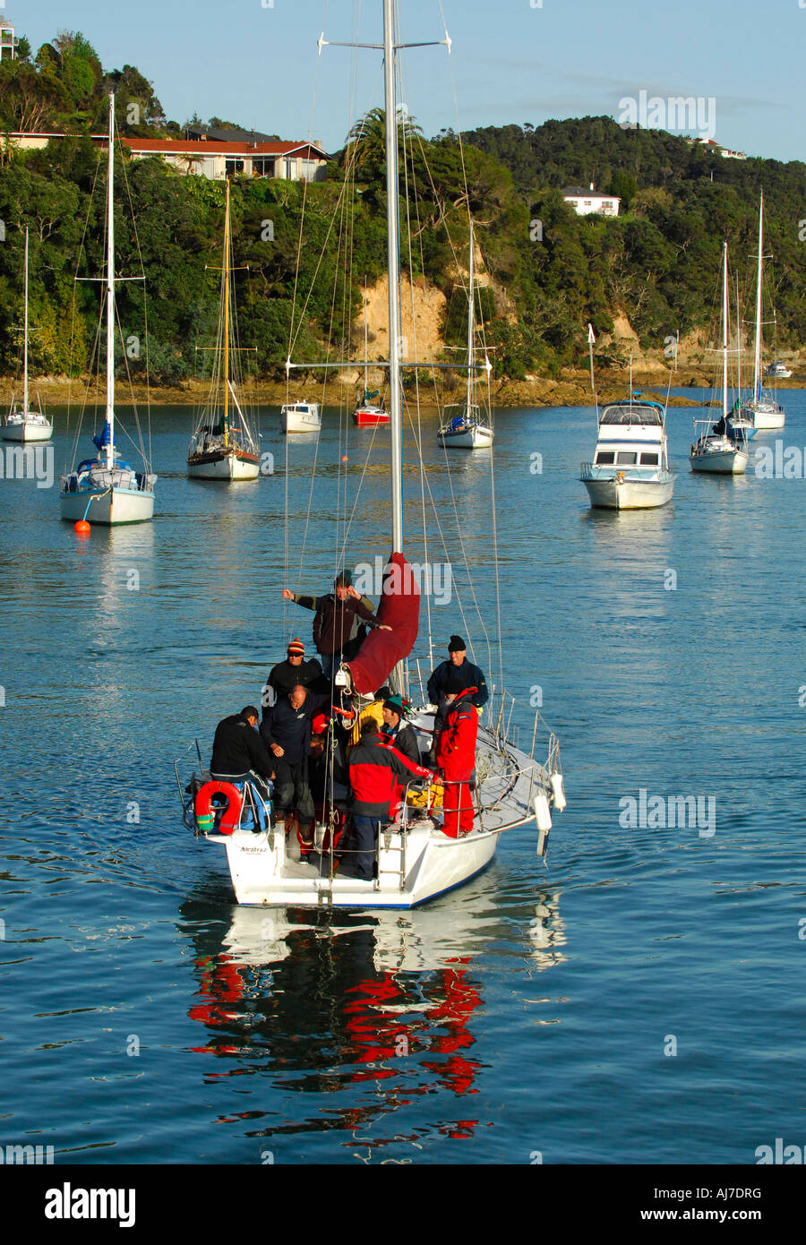 Sailing boat and crew in red weather gear, Opua harbour, Russell, Bay ...