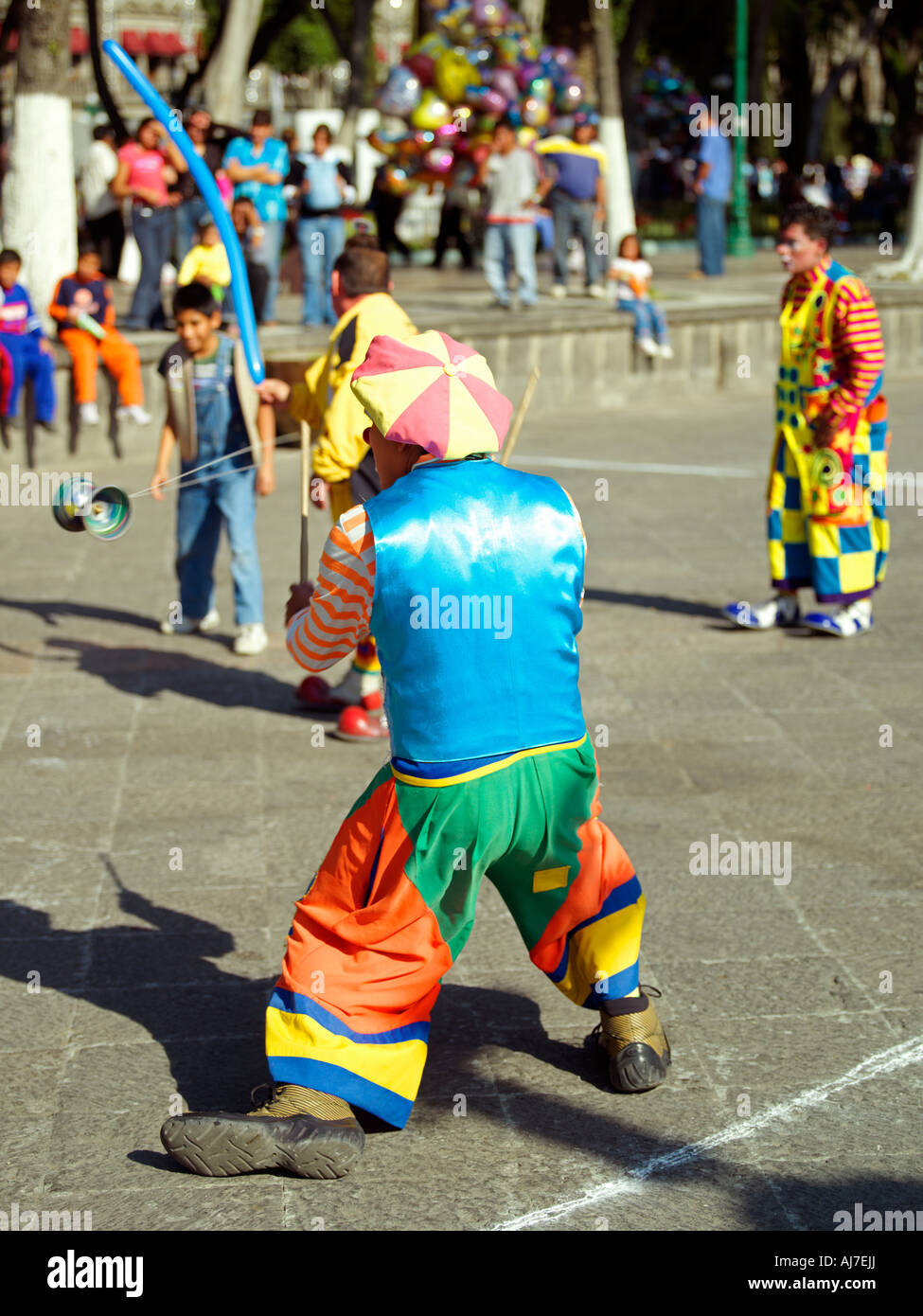 Clowns performing for the Sunday crowds in the Zocalo of Puebla Stock ...