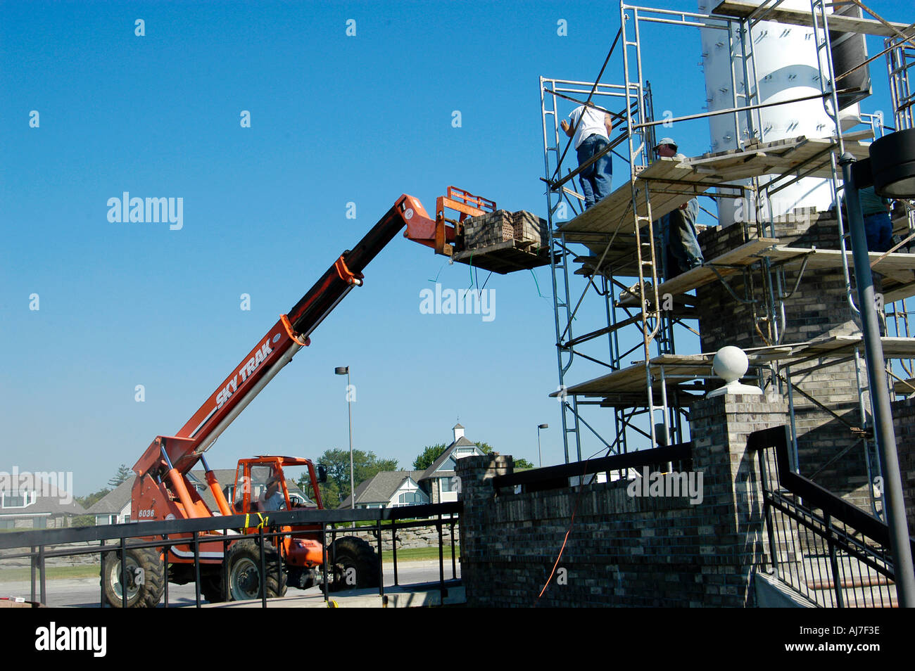 Brick Layers Build Tower tall brick tower Stock Photo - Alamy