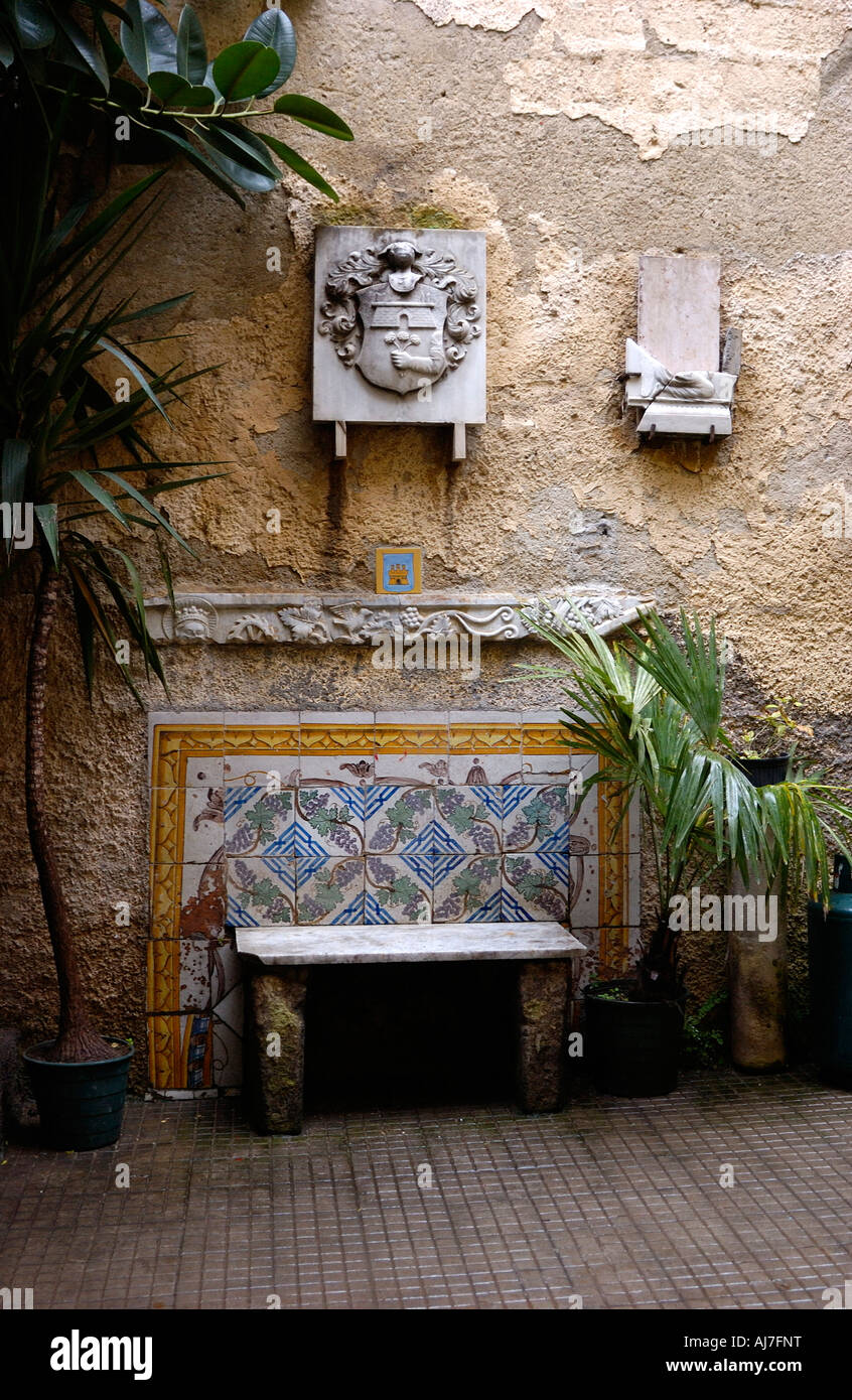 A stone bench in a small courtyard in Sorrento Italy with a ceramic ...