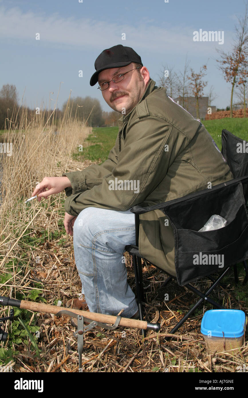 Fisherman smoking a cigarette while waiting for the fish to bite Stock ...