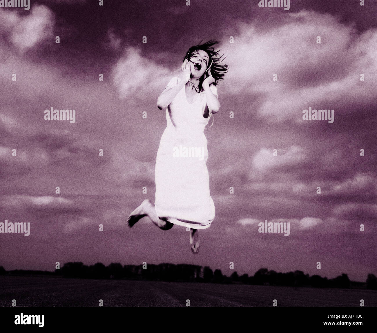 Screaming woman jumping outdoors Stock Photo - Alamy