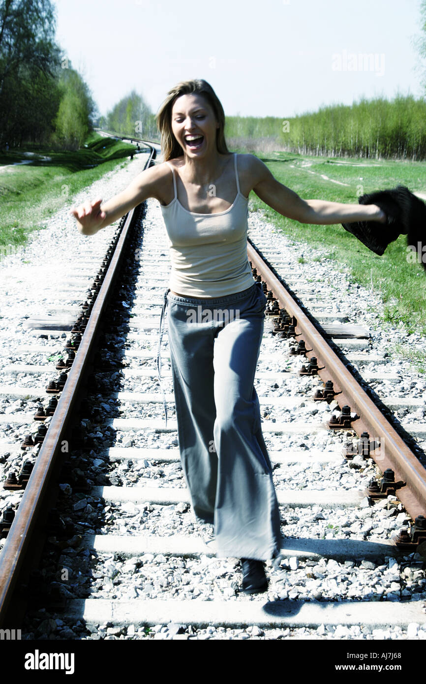 Woman walking on railroad tracks Stock Photo - Alamy