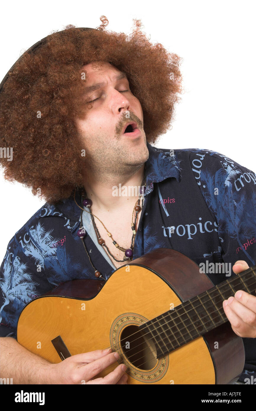 Hippie singing along with his guitar Stock Photo - Alamy
