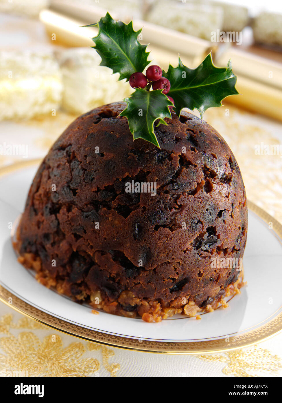 A Christmas pudding decorated with holly leaves Stock Photo - Alamy