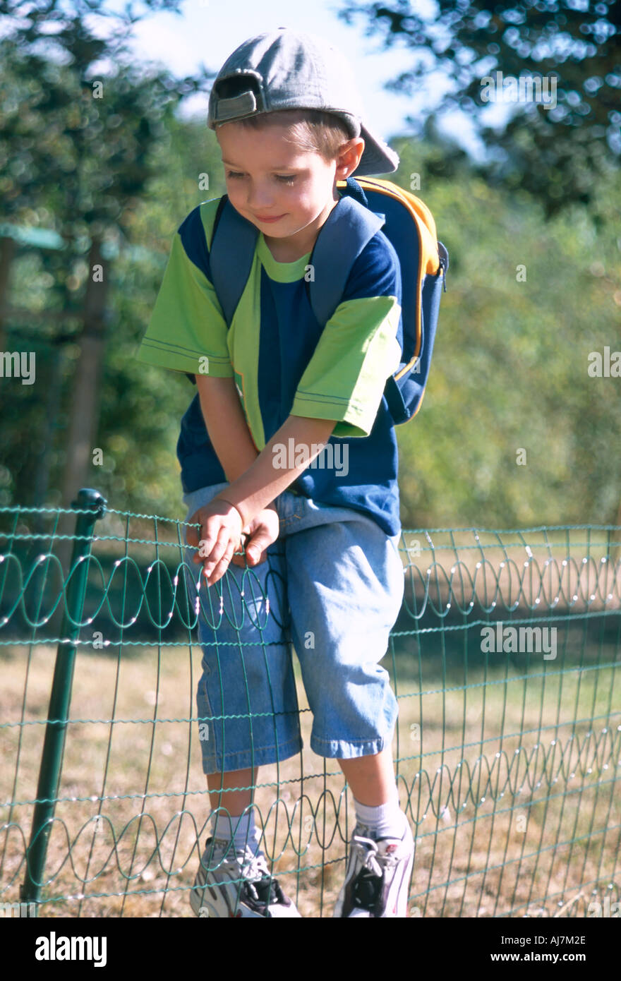 child boy schoolboy smile smiling knapsack cap passage passing barrier ...