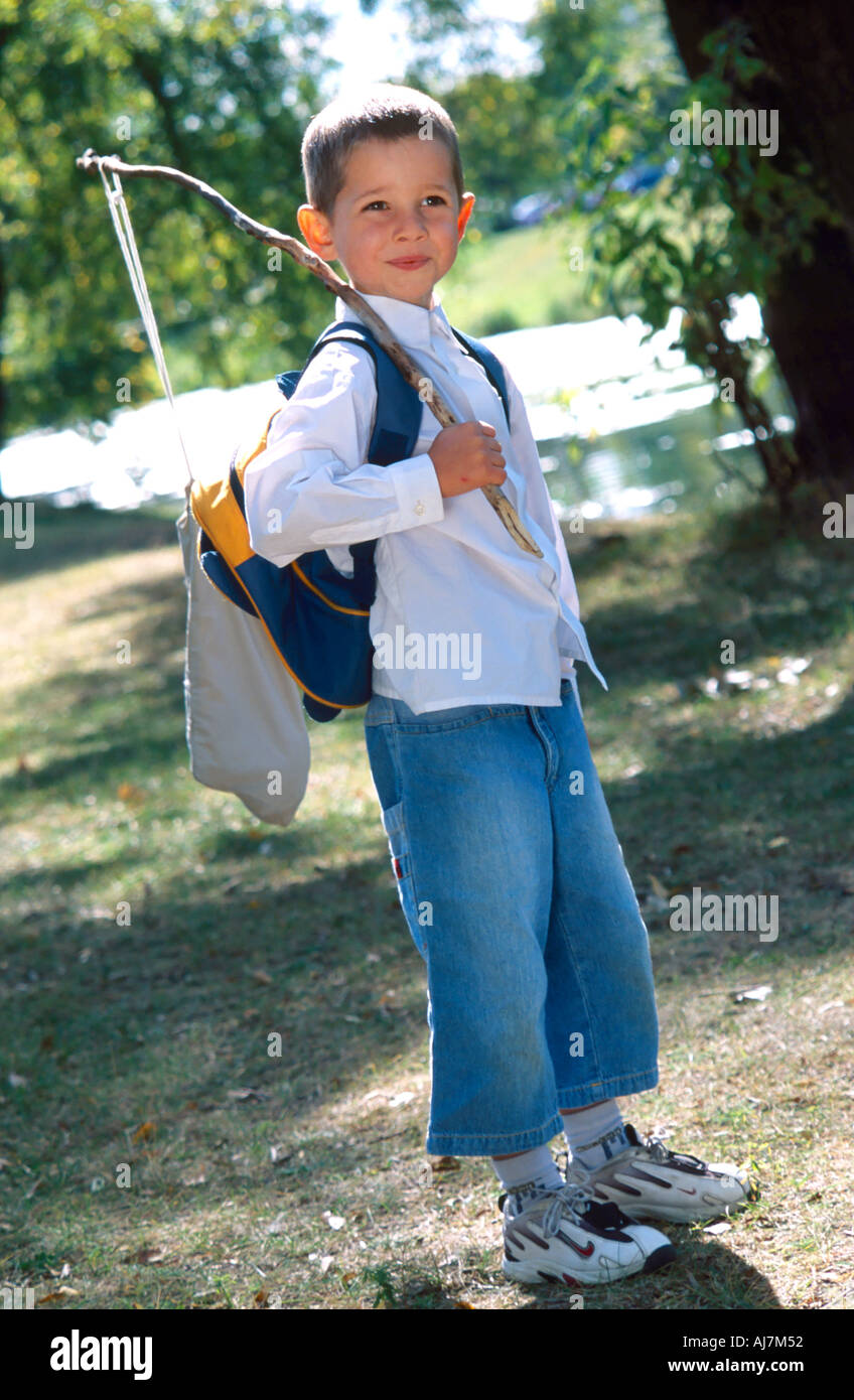 child boy schoolboy smile smiling knapsack jeans white shirt bag stand ...
