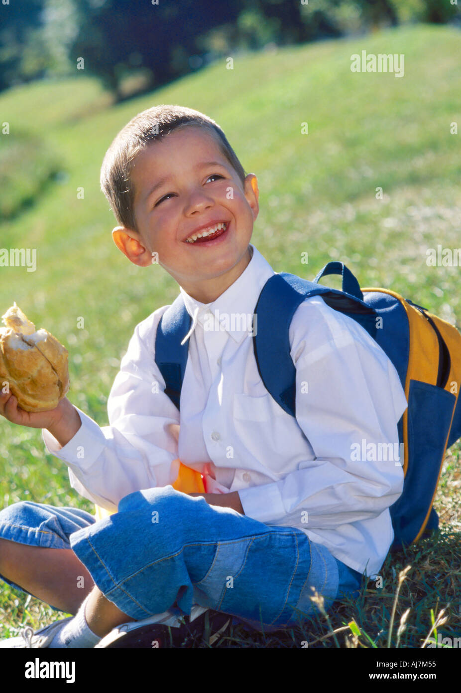 child boy schoolboy smile smiling knapsack jeans white shirt sit ...