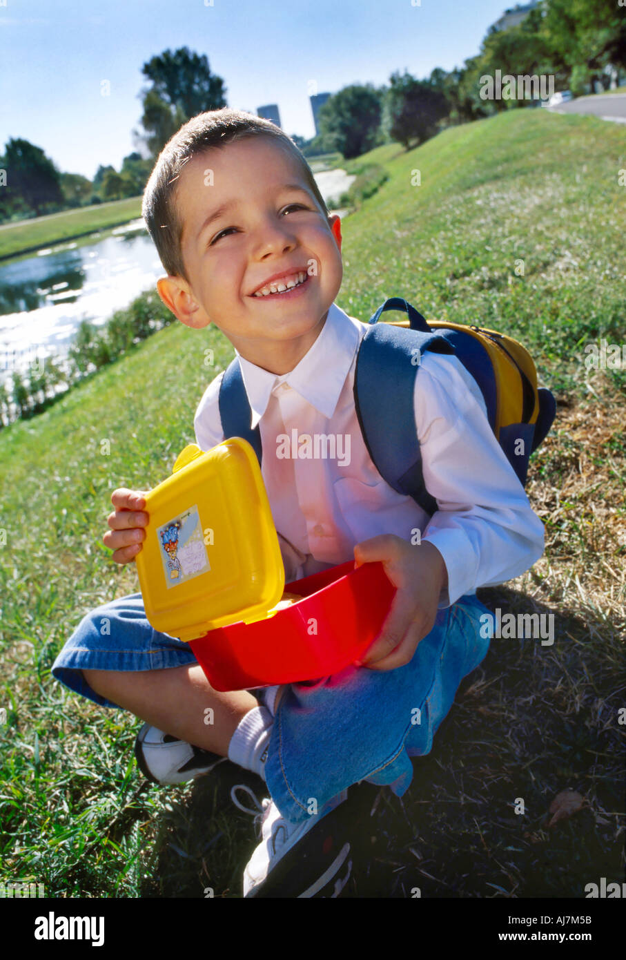 child boy schoolboy smile smiling knapsack jeans white shirt sit ...