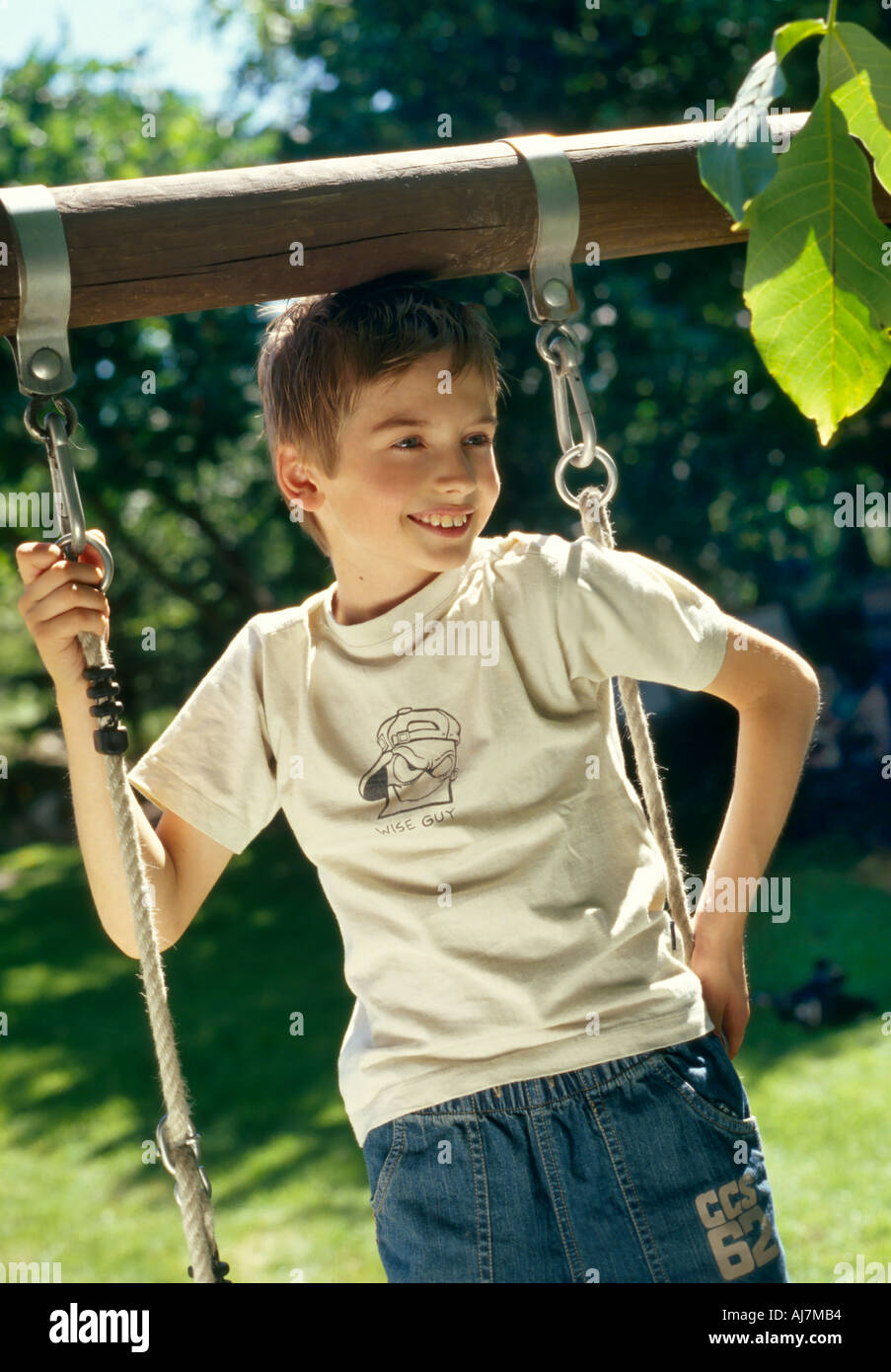 outdoor summer day park playground child boy blonde sit stand swing ...