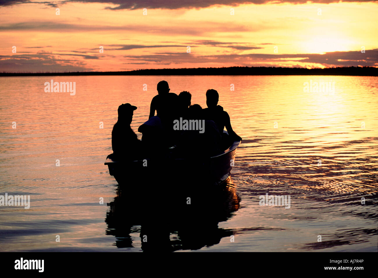 people in a boat during sunset Stock Photo - Alamy