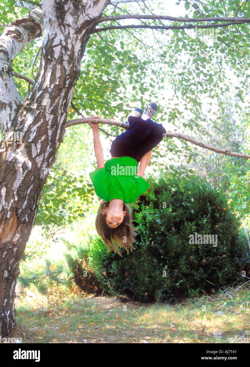 girl hangs from tree Stock Photo - Alamy