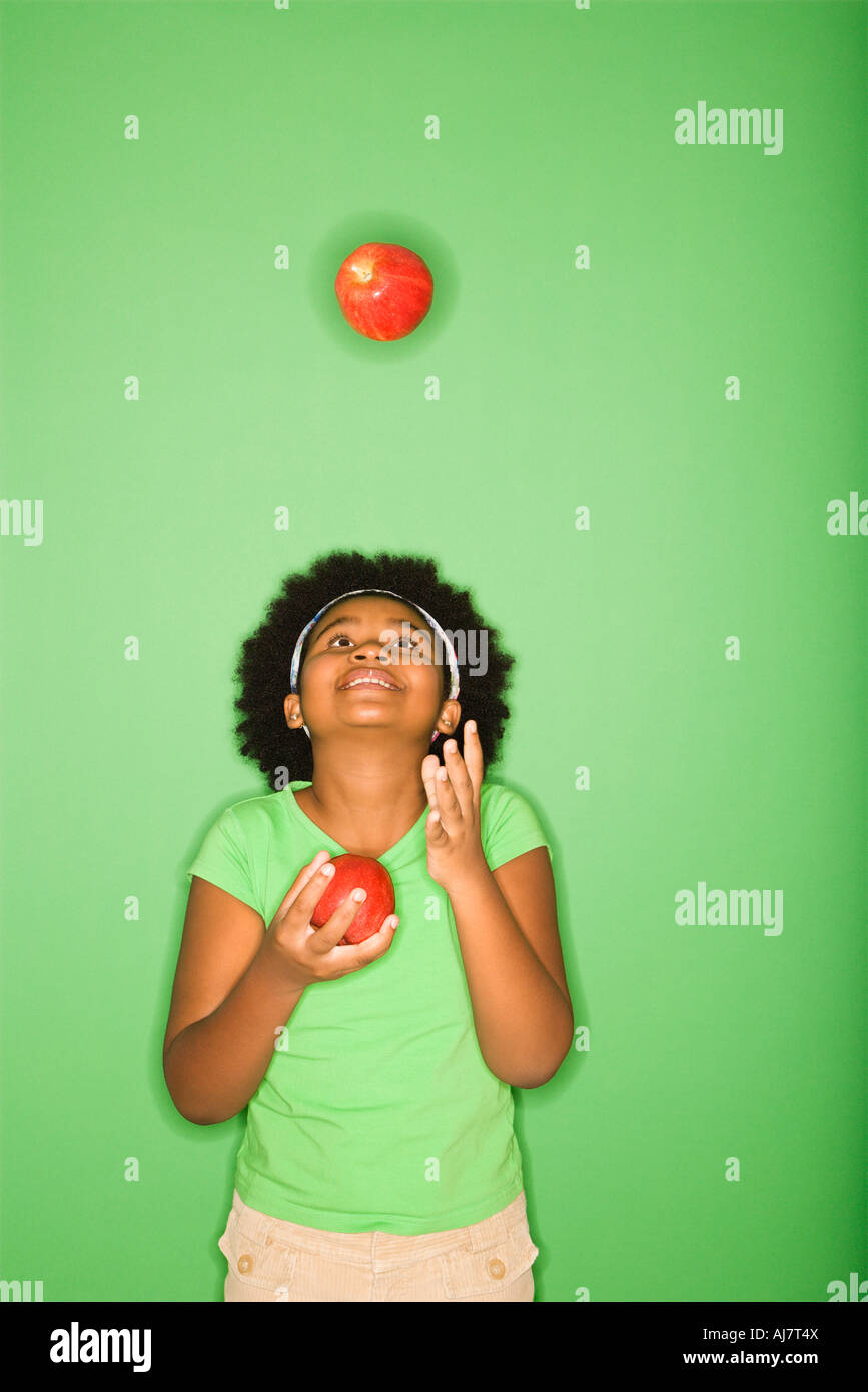 African American girl juggling apples Stock Photo - Alamy