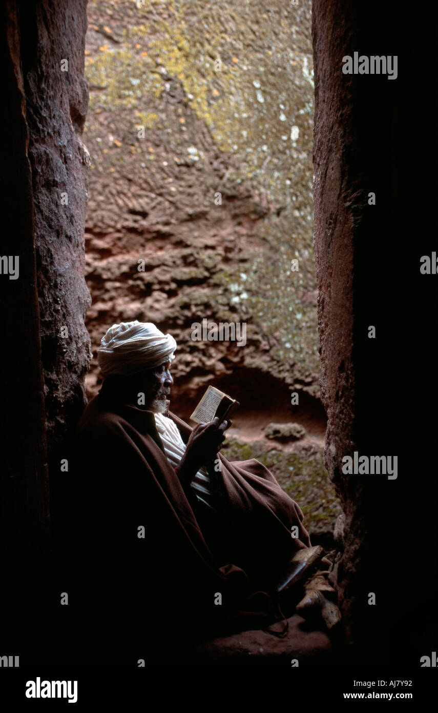 Pilgrim reading a bible in the doorway of Bet Debre Sina (Church of Mt ...