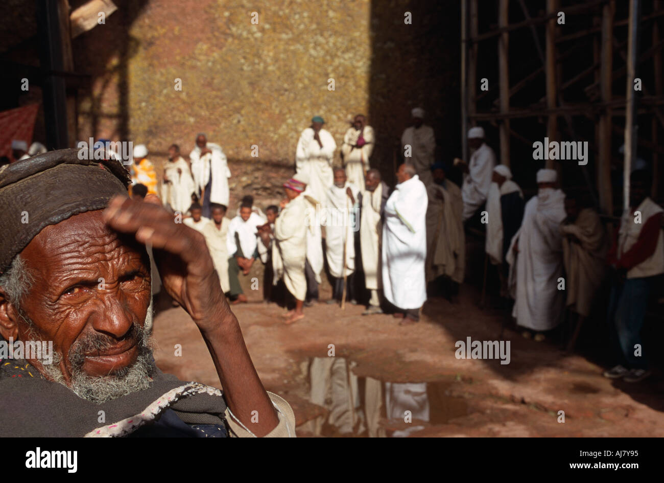 Old pilgrim in the sunken courtyard of the Bet Maryam (Church of the ...