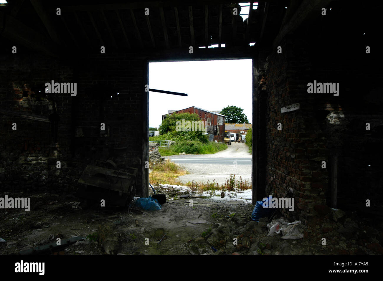 The view to a neighbouring farm, from the inside of an old farm ...