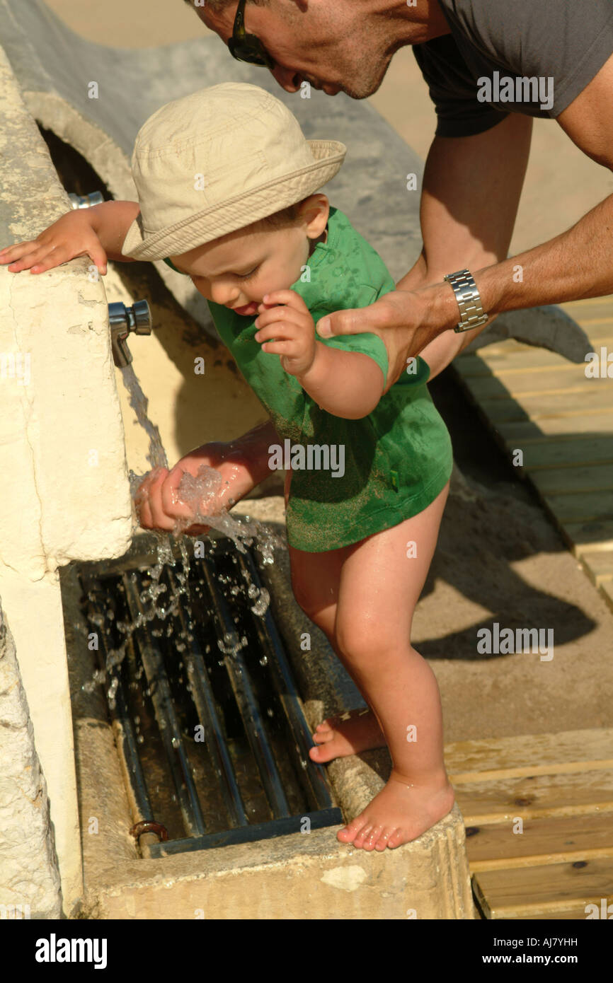 Washing sand off at beach hi-res stock photography and images - Alamy