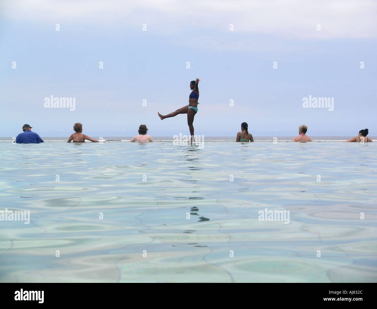Aerobics teacher leads exercise class in hotel pool, Mauritius Stock ...