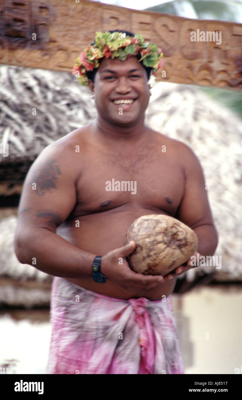 Man demonstrating how to split a coconut Cook Islands Stock Photo - Alamy